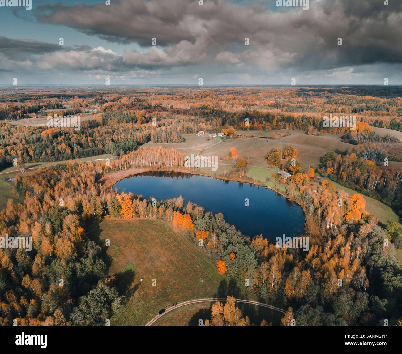Aerial view of Sibulajärv lake with dramatic clouds in fall season ...