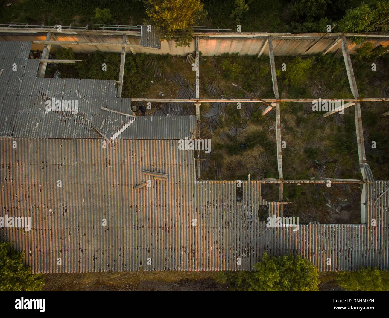 Aerial view of broken roof of an abandoned industrial warehouse in ...