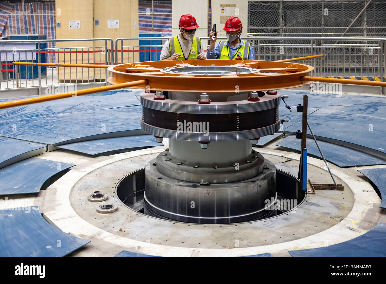 NANNING, CHINA - APRIL 15, 2025 - Builders inspect the generator ...