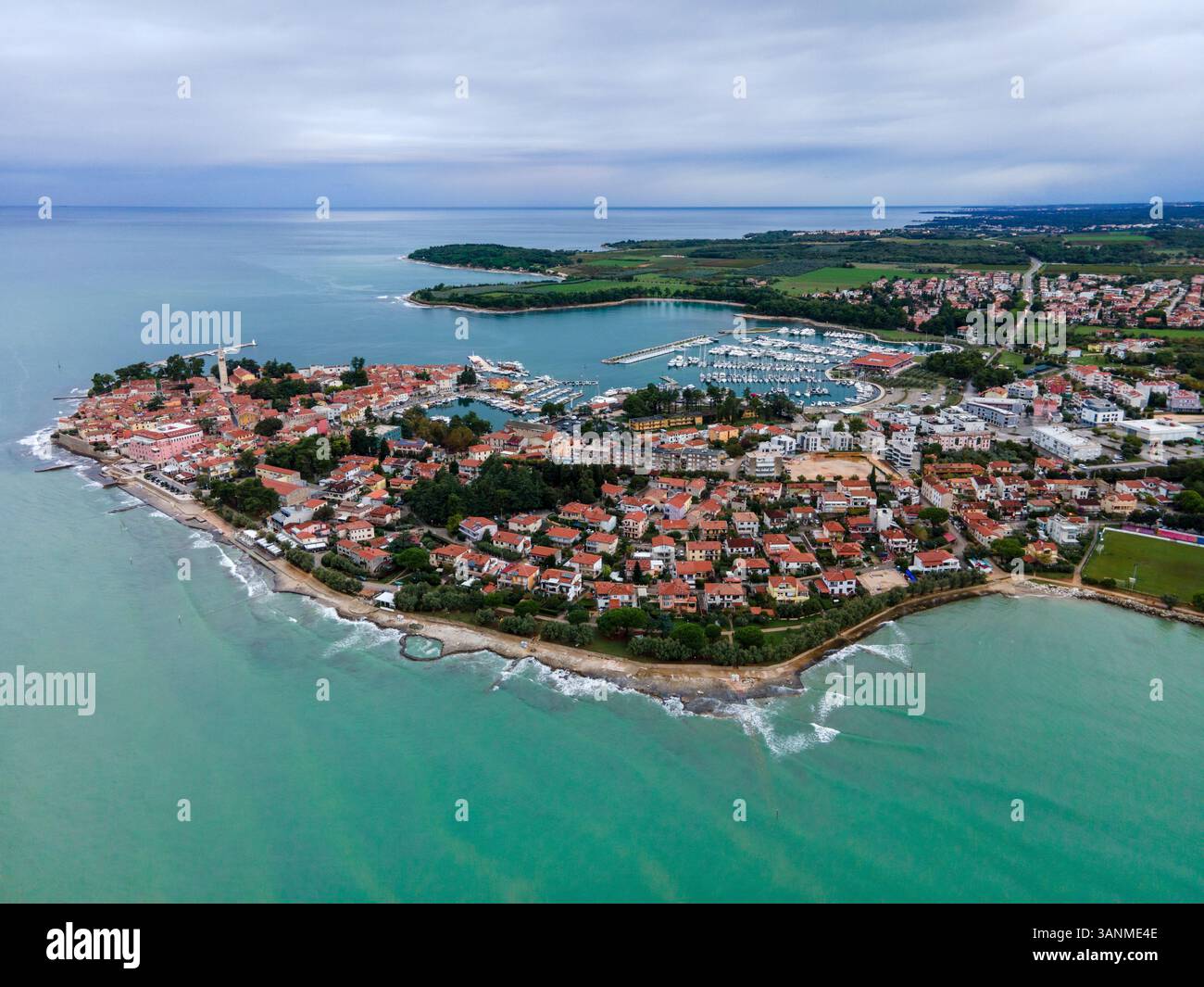 Aerial view of beautiful coastal town with sailboats in the harbour at ...
