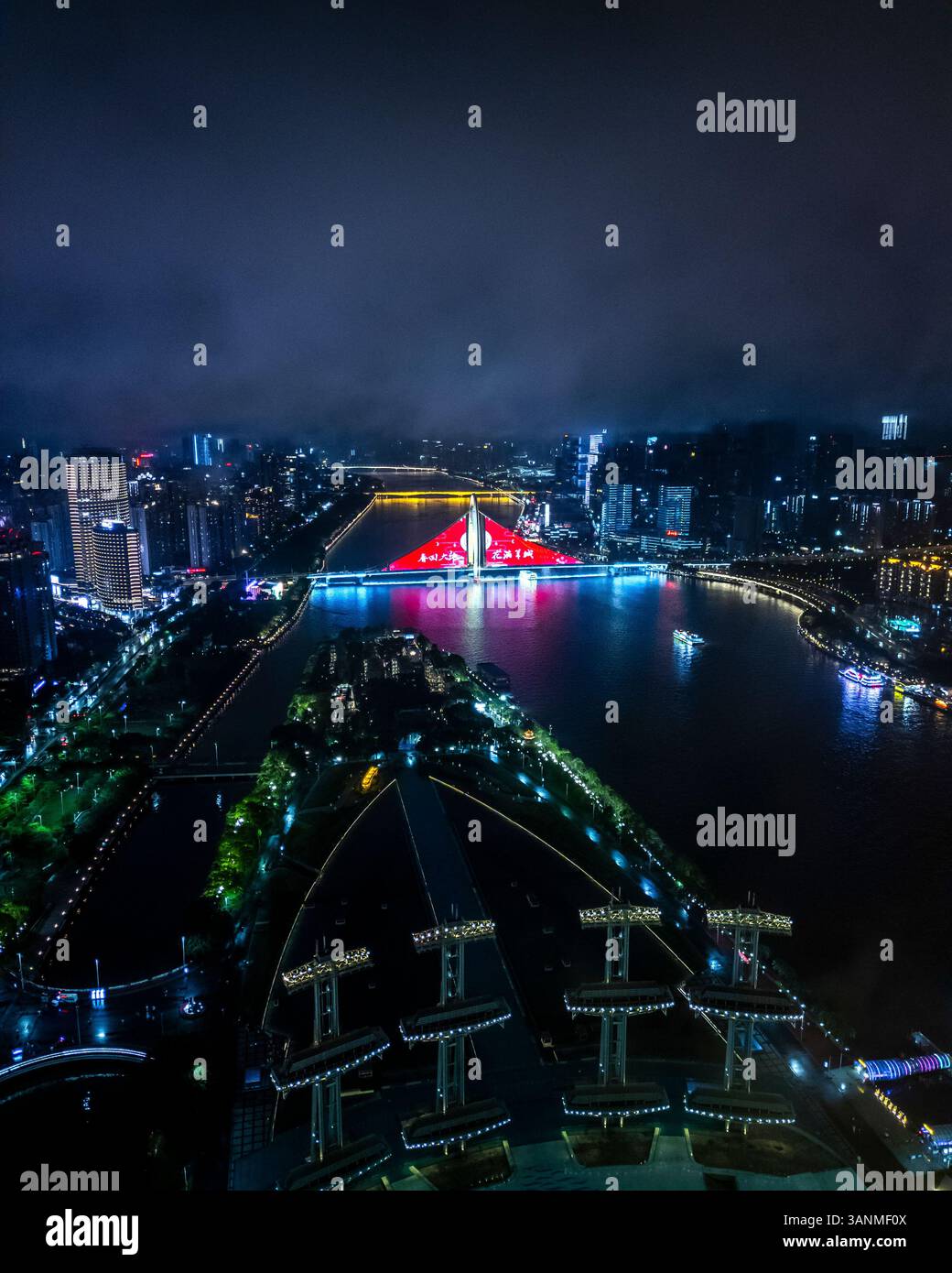 Aerial view of vibrant cityscape with illuminated Liede Bridge over the ...