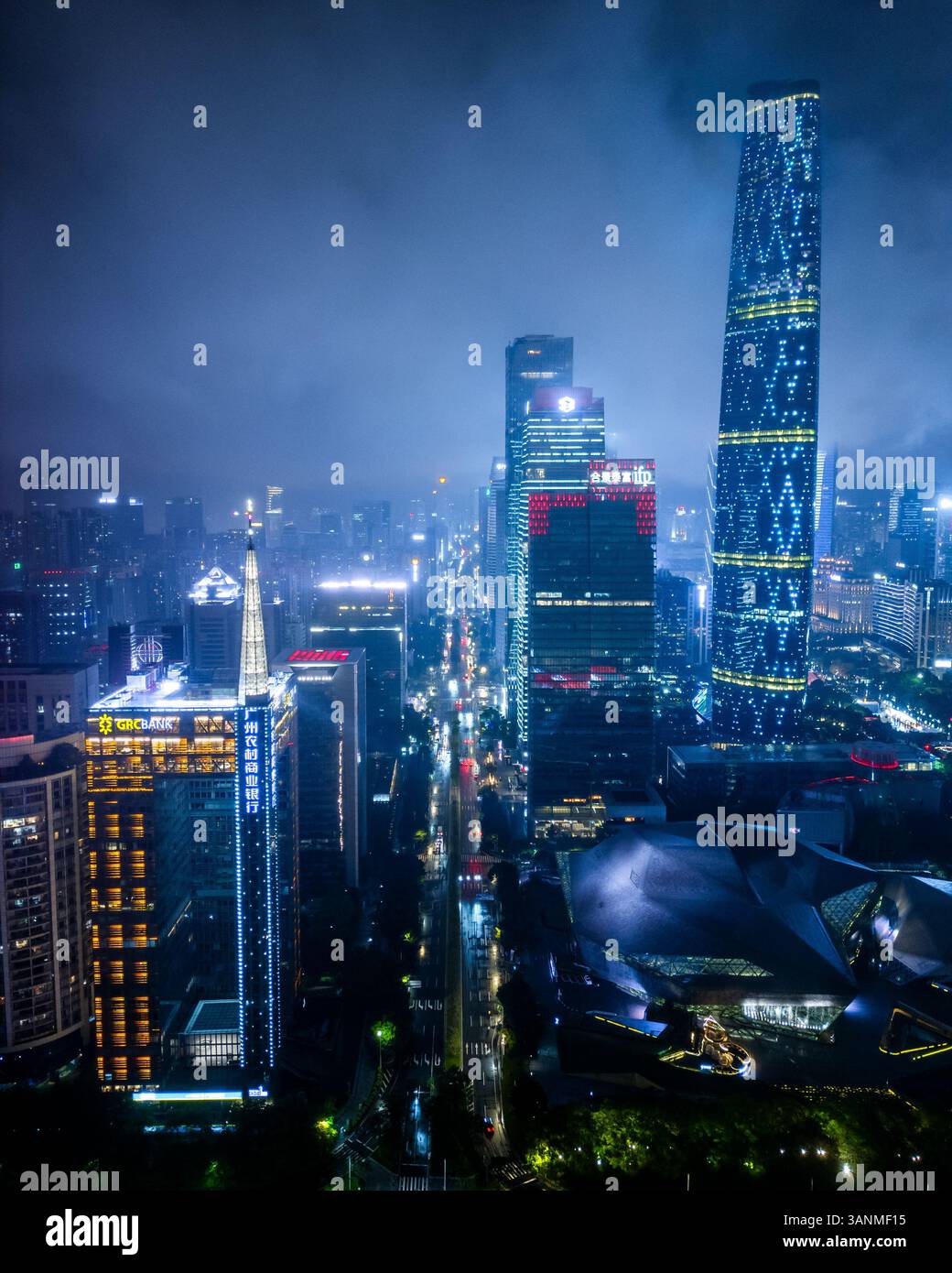 Aerial view of vibrant and illuminated cityscape with towering skyscrapers and bustling streets ...