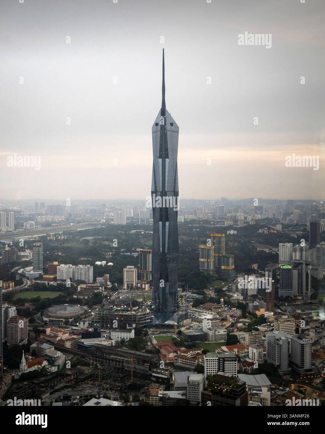 Aerial view of Merdeka 118 skyscraper illuminated at sunset in the ...