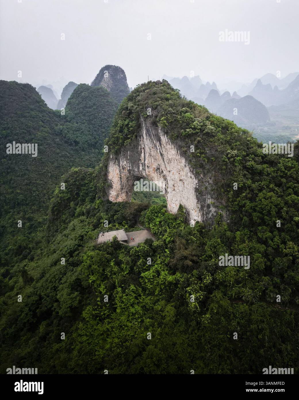 Aerial view of the majestic Moon Hill with lush greenery and rocky ...