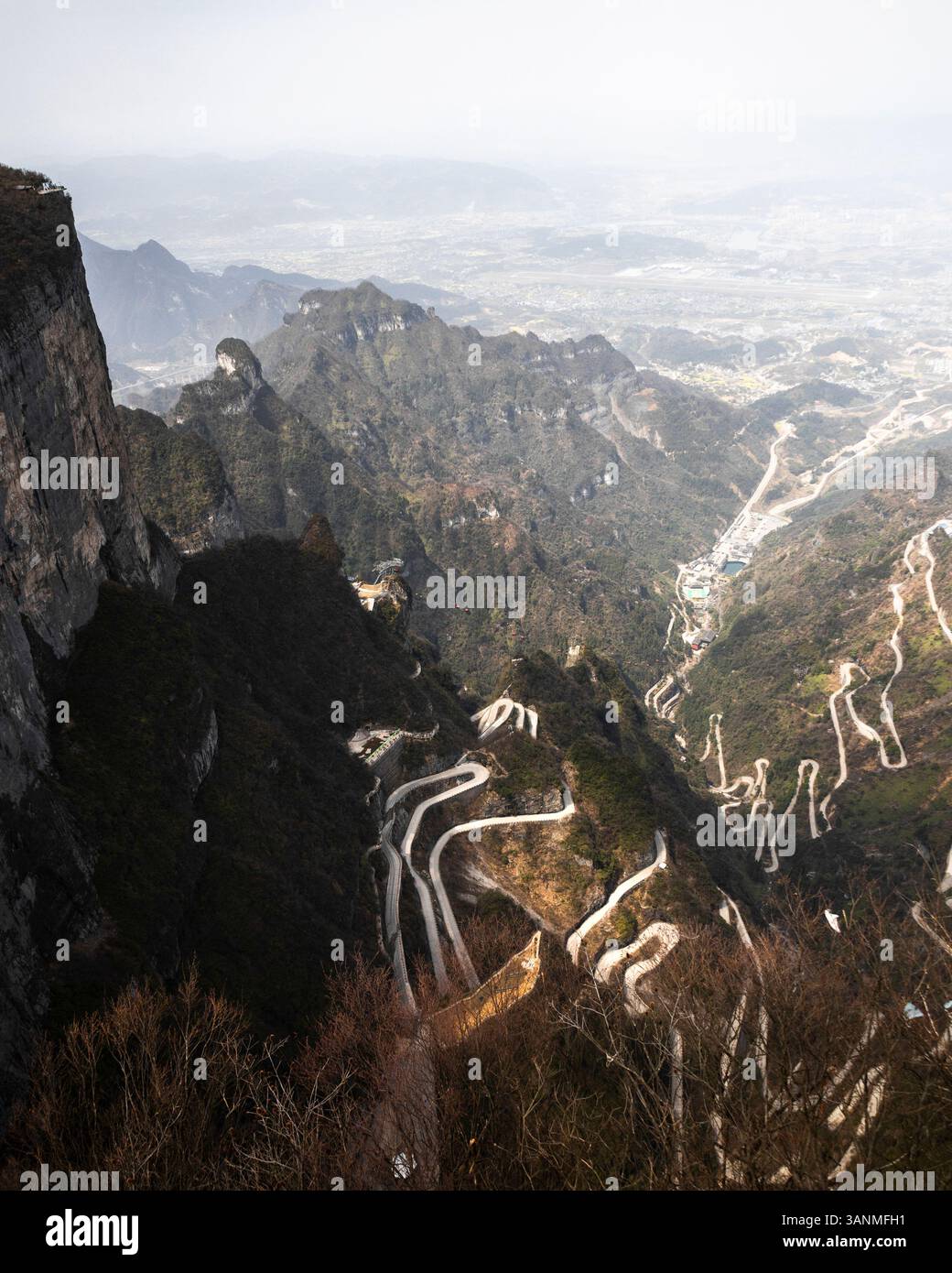 Aerial view of the majestic Tianmen Mountain with a winding road and ...