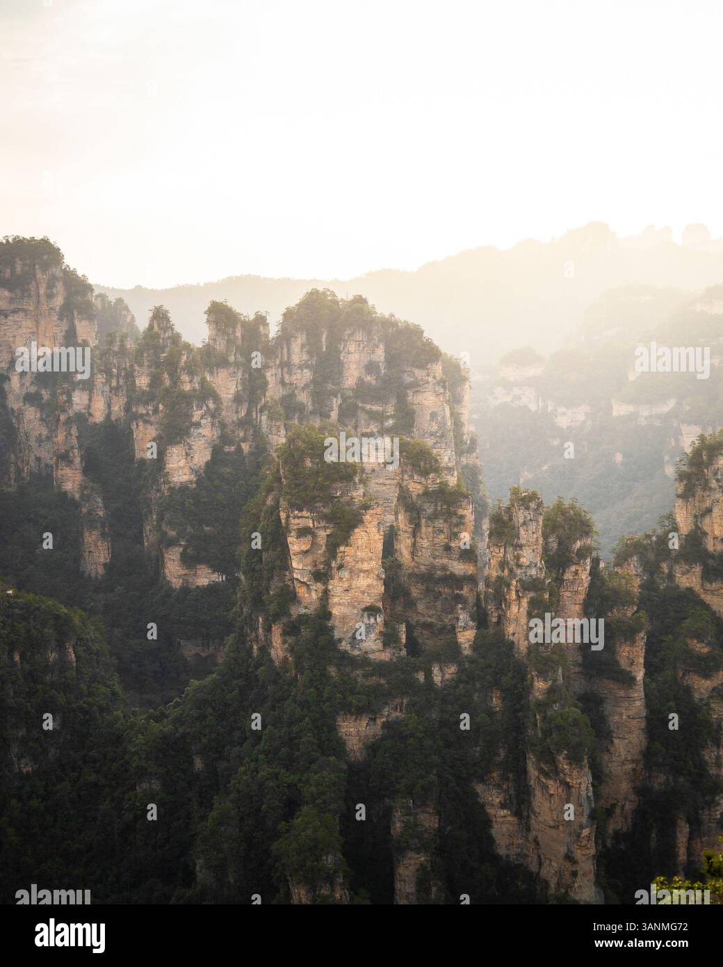 Aerial view of majestic rock formations and vertical cliffs in a misty ...