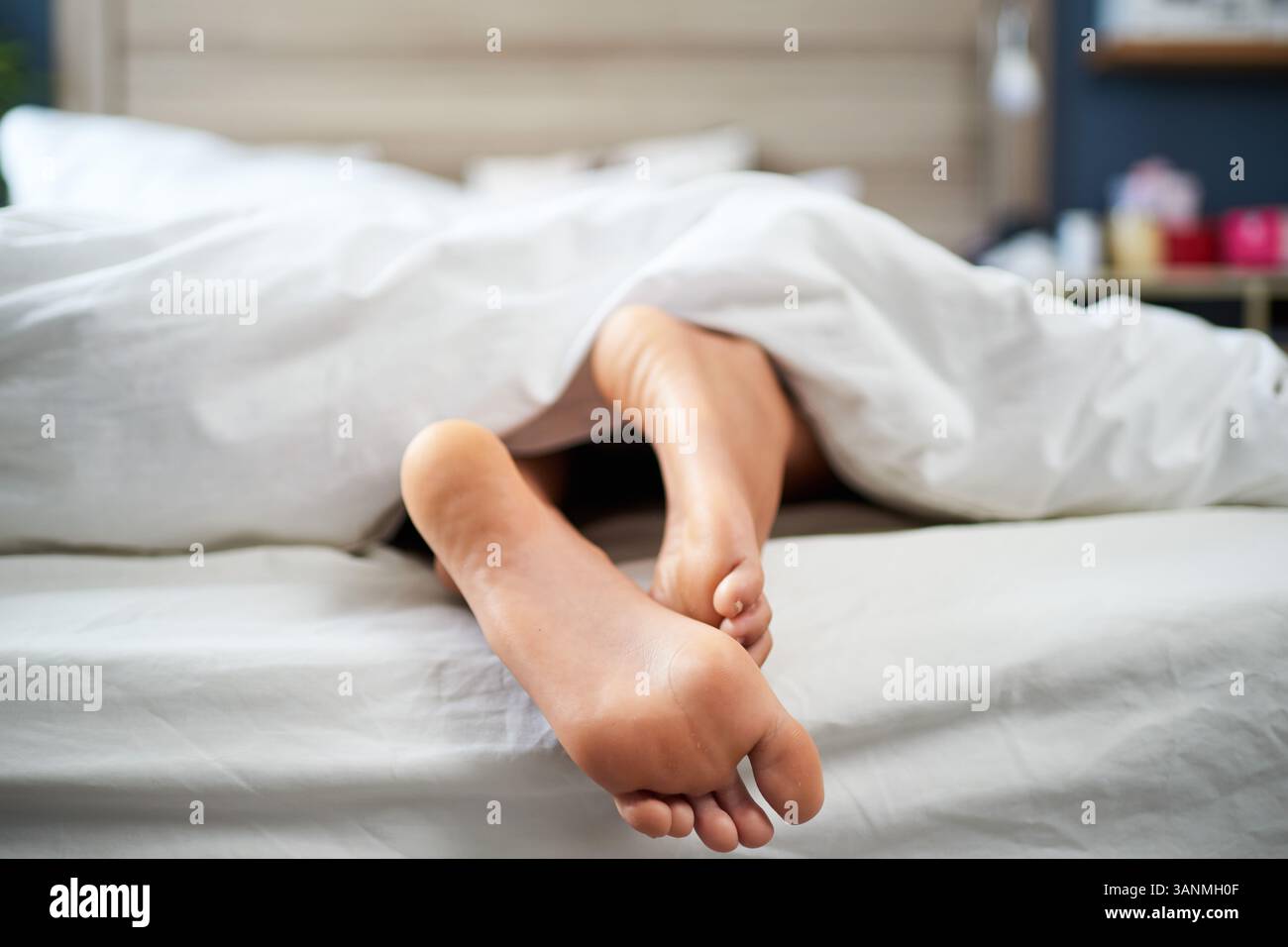 Feet of a Relaxed Couple Resting Together Under a Cozy White Blanket in ...