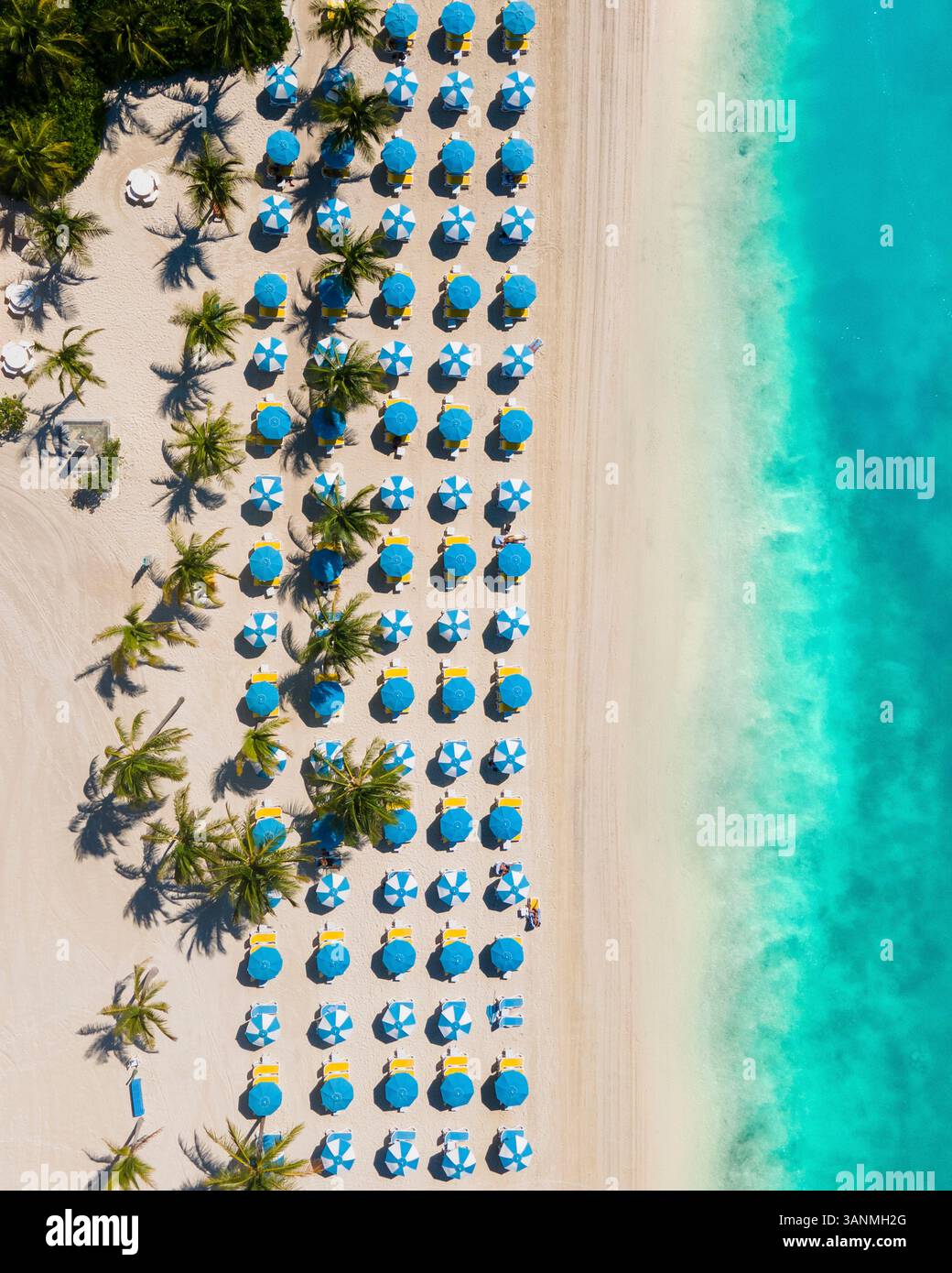 Aerial view of turquoise waters and sandy beaches with parasols, Coco ...