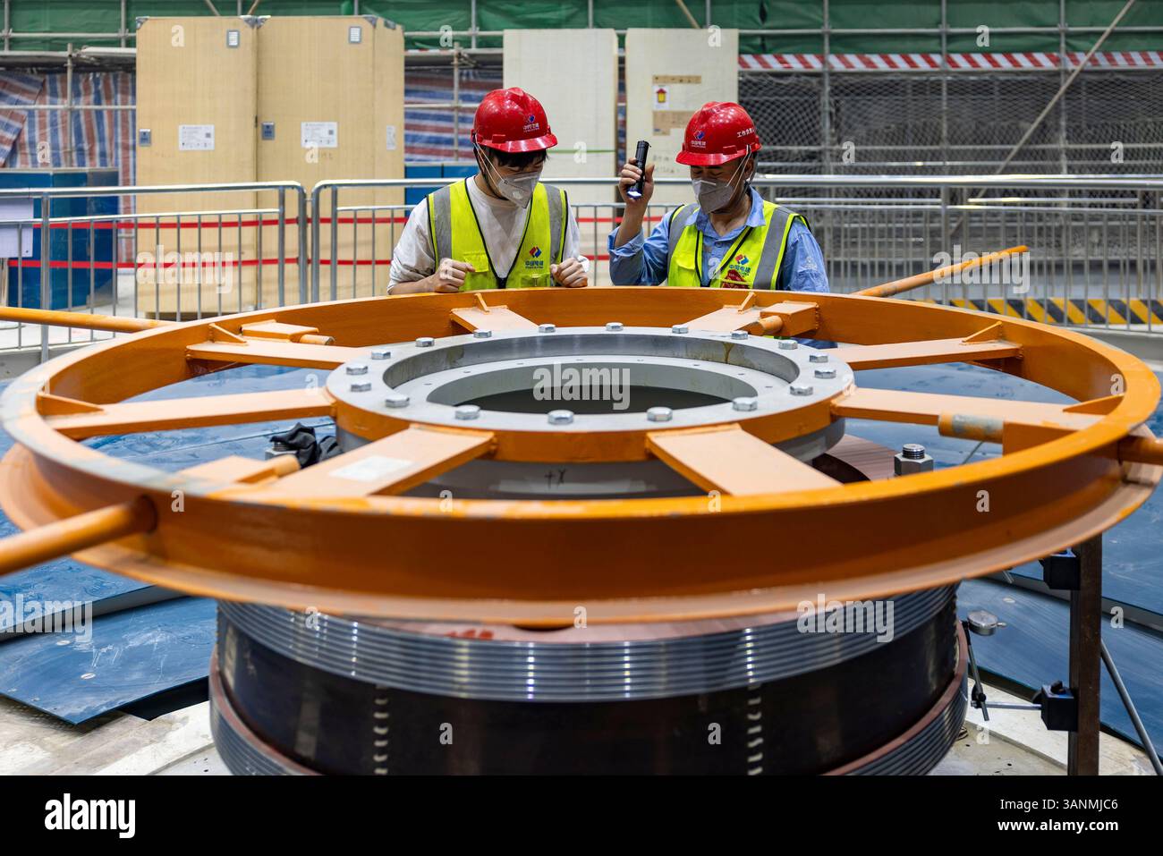 NANNING, CHINA - APRIL 15, 2025 - Builders inspect the generator ...