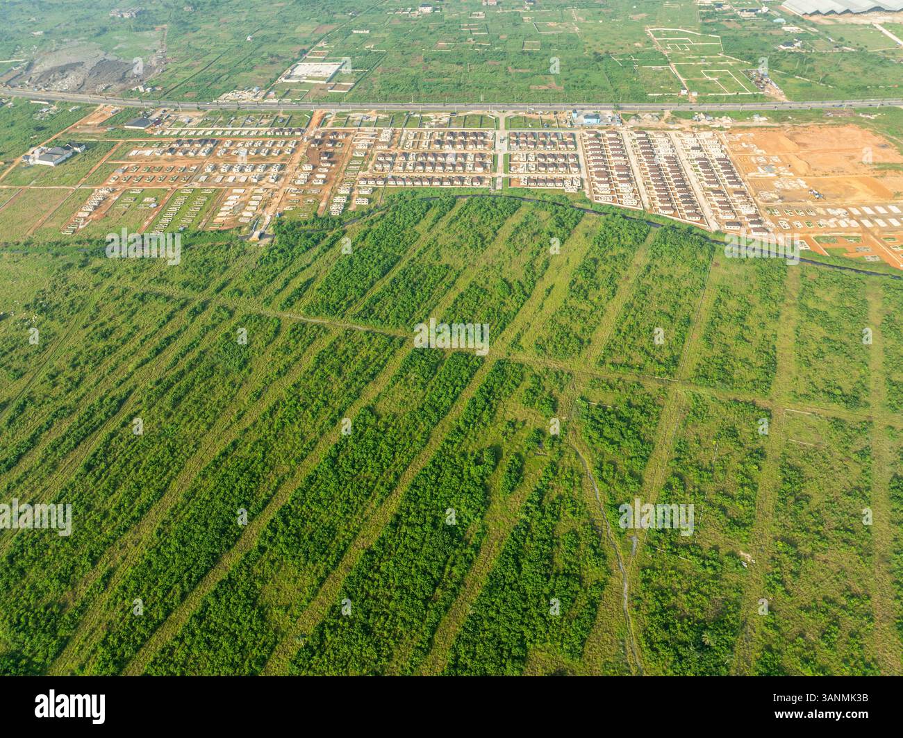 Aerial view of green farmland and residential areas with urban ...