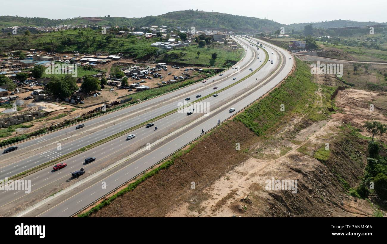 Aerial view of scenic highway with cars amidst lush greenery and ...