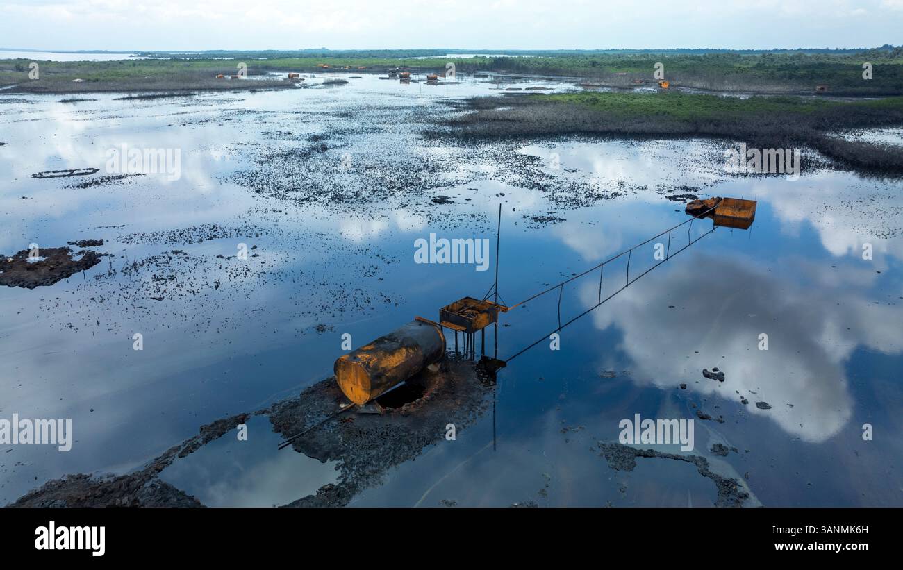 Aerial view of polluted wetlands with oil spillage and rusty industrial ...