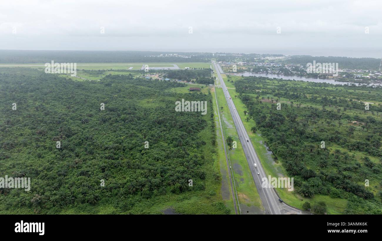 Aerial view of lush workers camp surrounded by tranquil forest and road ...