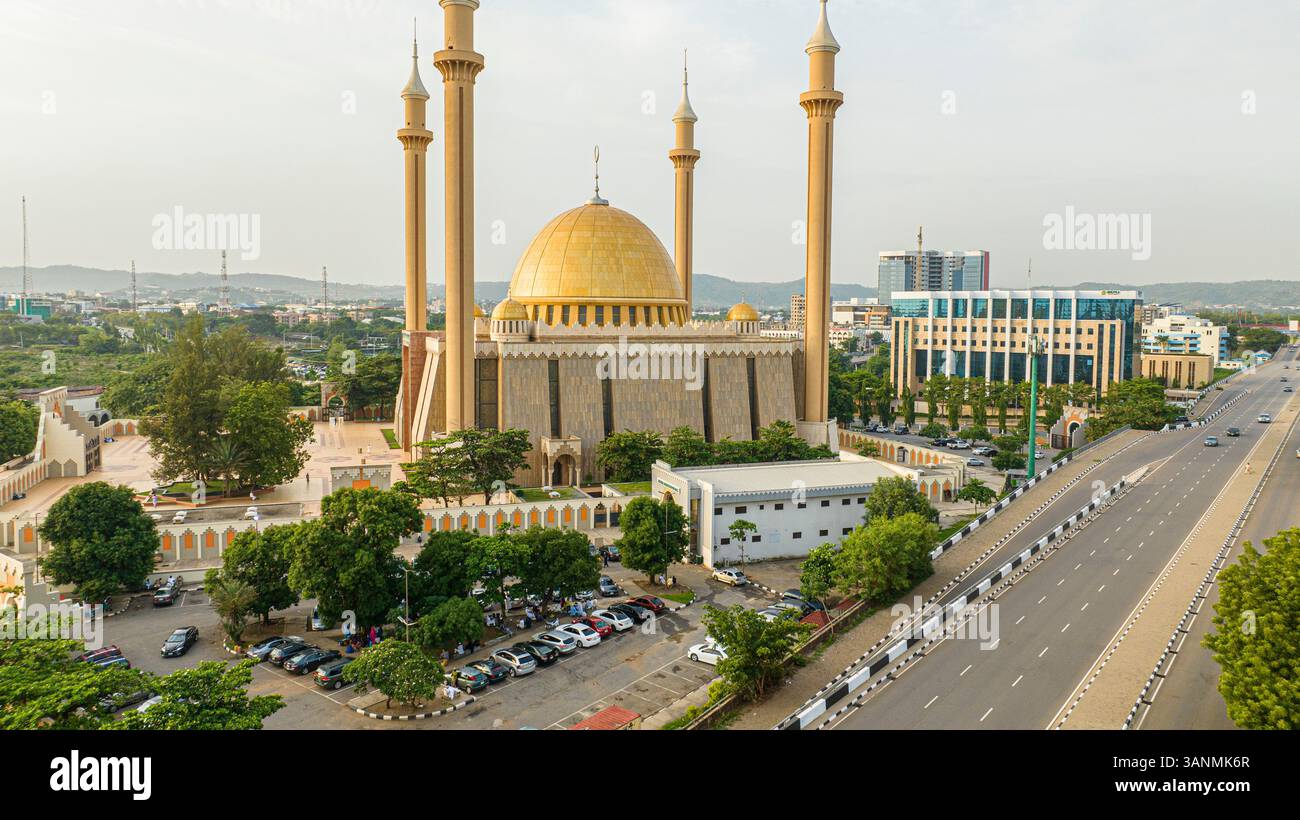 Aerial view of beautiful mosque surrounded by urban buildings and ...