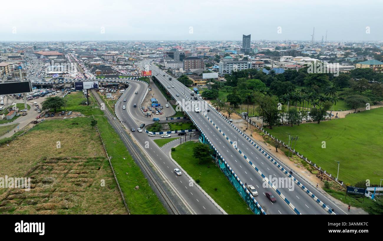 Aerial view of busy highway and train road with modern buildings and ...