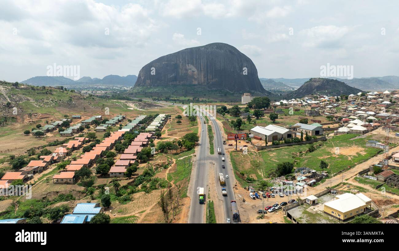 Aerial view of zuma rock surrounded by urban homes and rural landscape ...