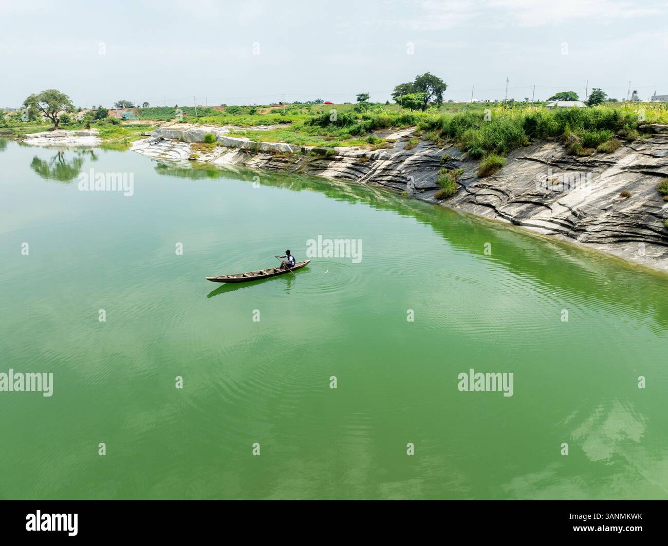 Aerial view of serene lake with canoe and tranquil reflections, Chikun ...