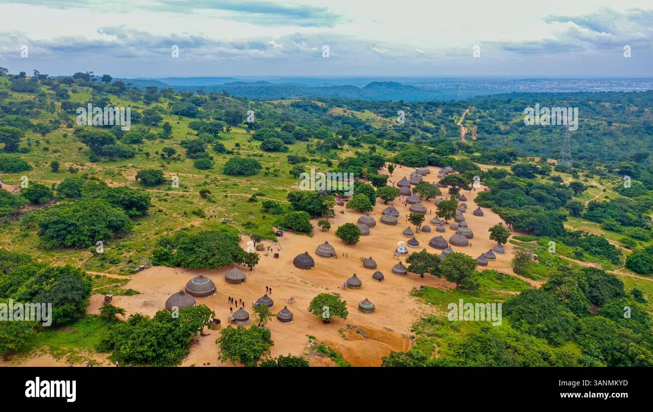 Aerial view of a picturesque village with traditional huts surrounded ...