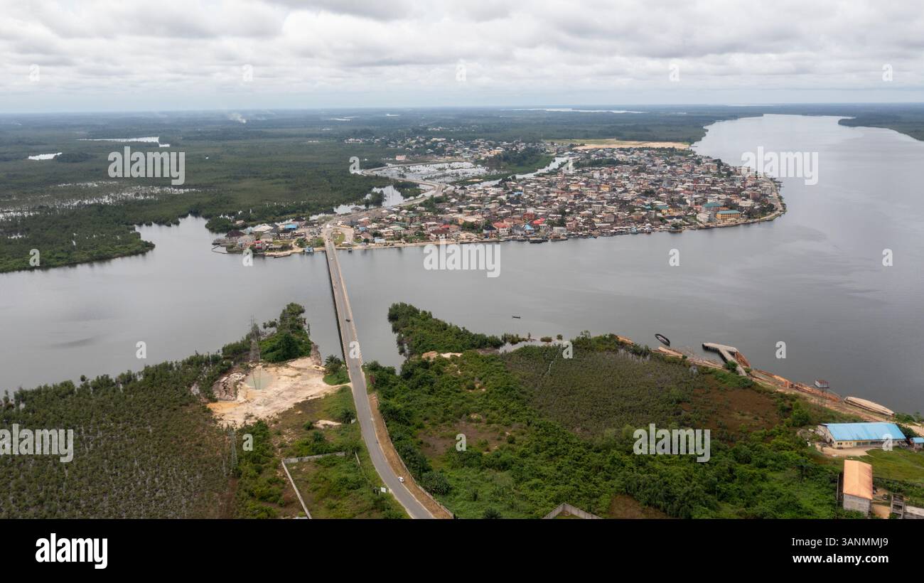 Aerial view of a beautiful town with a scenic river and bridge, Degema ...