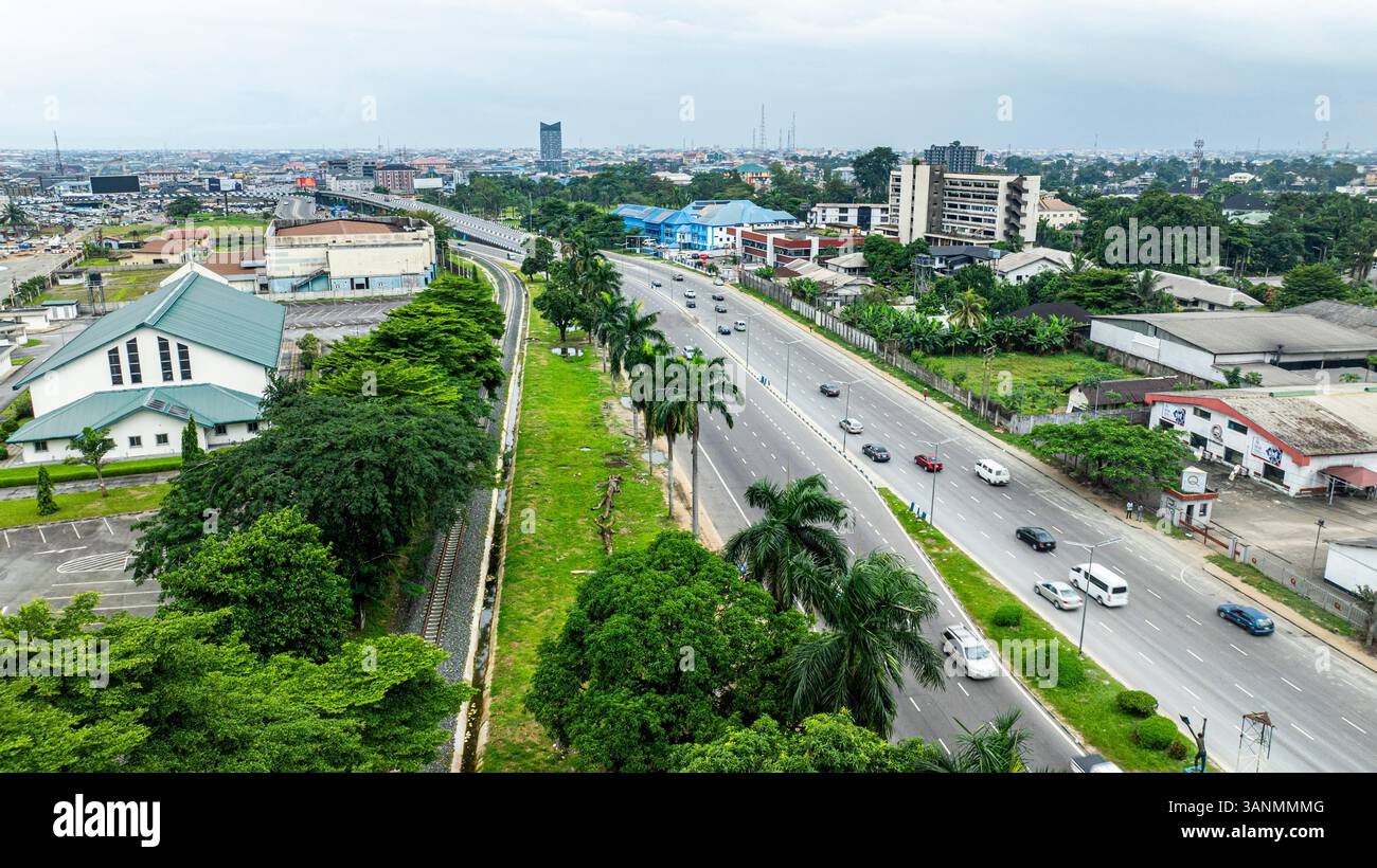Aerial view of bustling highway surrounded by palm trees and modern ...