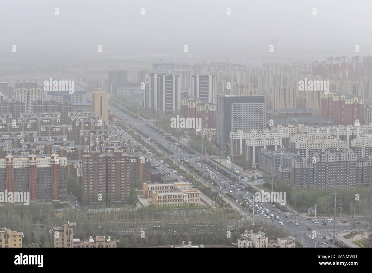 Buildings loom under the sand and dust in Yinchuan, Ningxia Province ...
