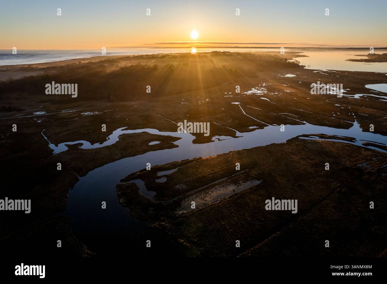 Aerial view of serene wetlands and forest at sunrise over Ipswich River ...