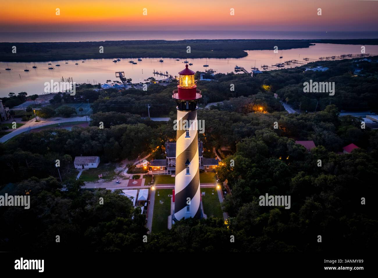 Aerial view of St. Augustine Lighthouse at sunset with coastal horizon ...