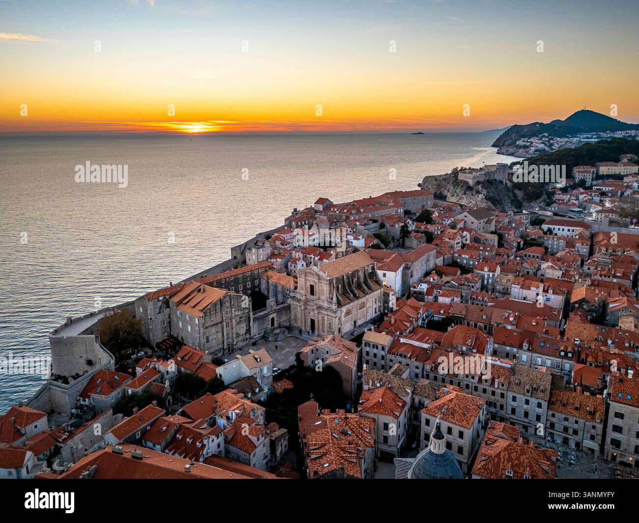 Aerial view of historic cityscape with orange rooftops and coastline at ...