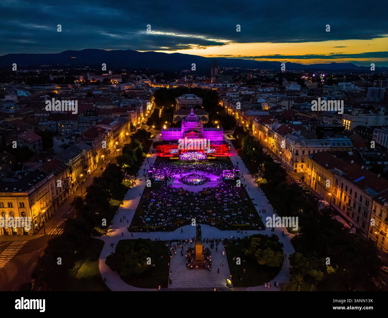 Aerial view of vibrant concert in old town with illuminated buildings ...