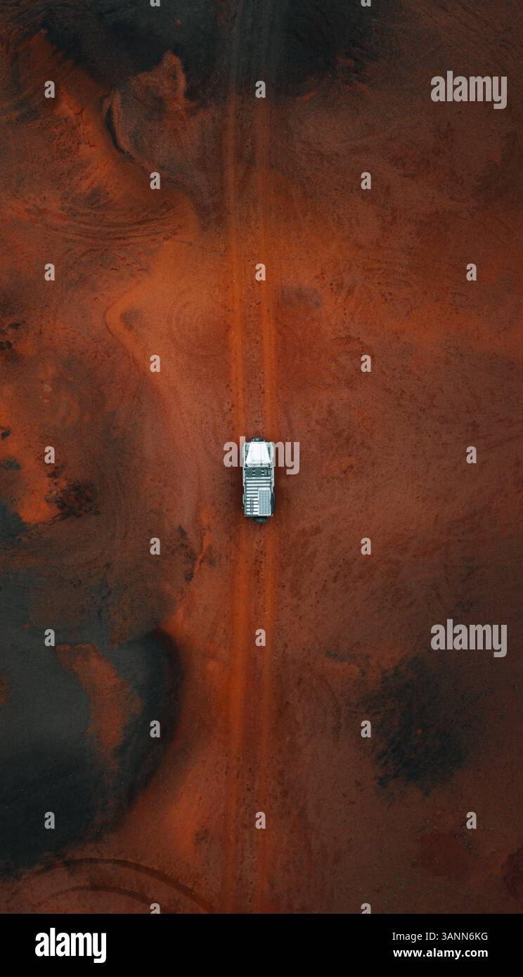 Aerial view of a land rover defender on a rugged dirt road in a ...