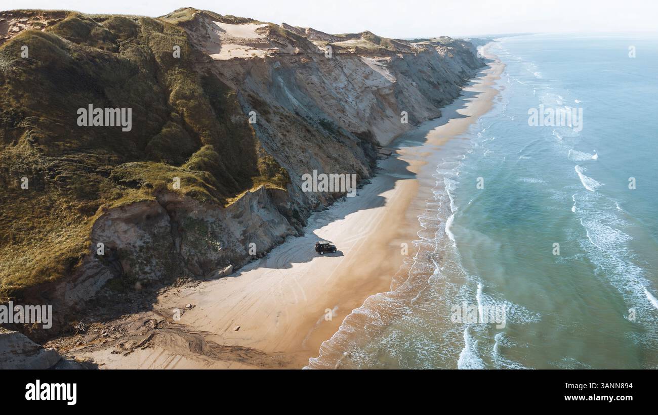 Aerial view of sandy beach with blue ocean waves, Nr. Lyngby, Jutland ...