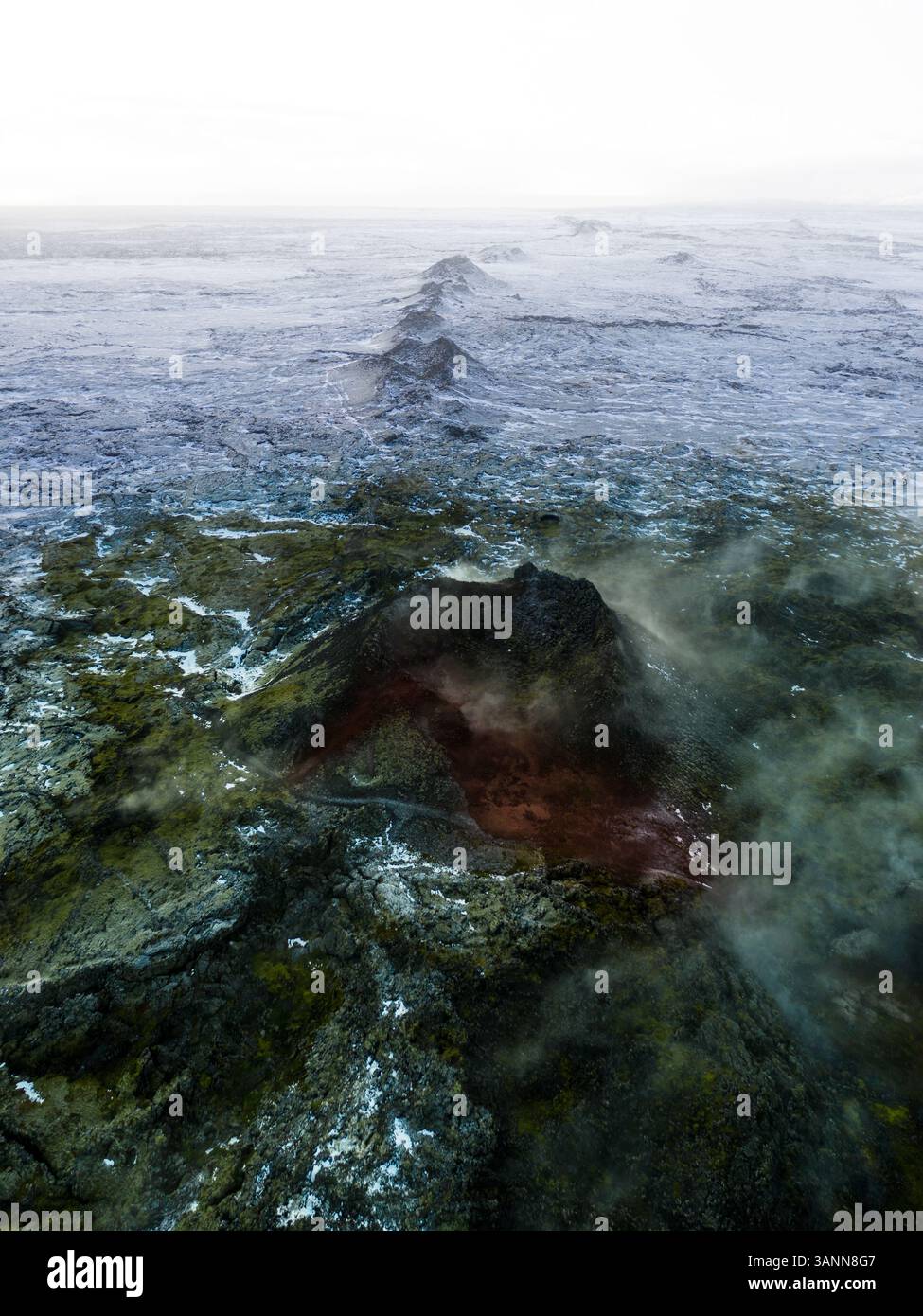 Aerial view of a steaming row of volcanic craters, releasing geothermal ...