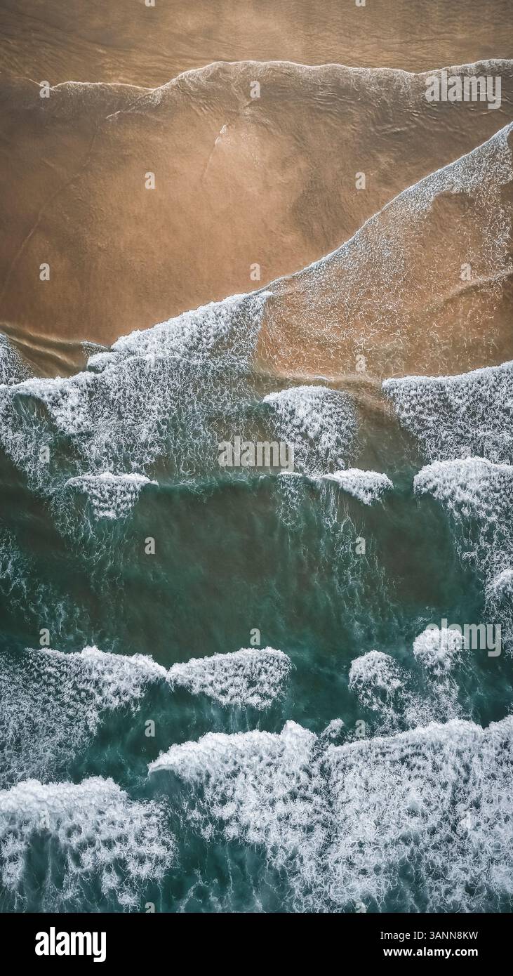 Aerial view of sand beach with crashing waves, Pukenui, New Zealand ...