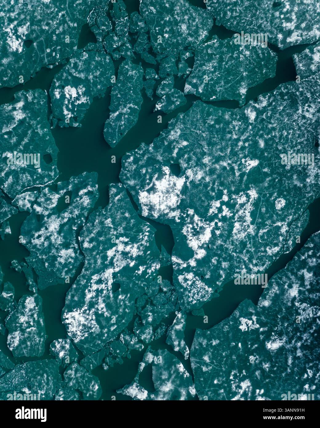 Aerial view of beautiful patterns created by frozen ice on turquoise ...