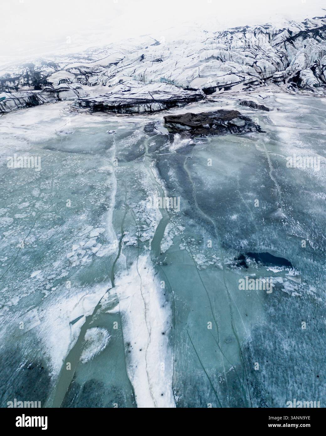 Aerial view of glacier Solheimajokull, with black and white patterns ...