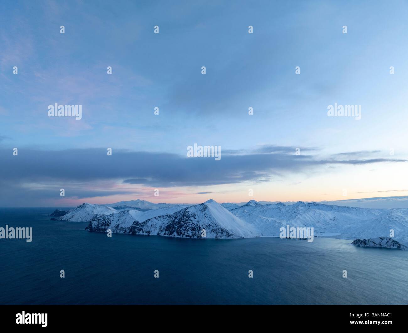 Aerial view of unalaska bay surrounded by majestic mountains and icy ...
