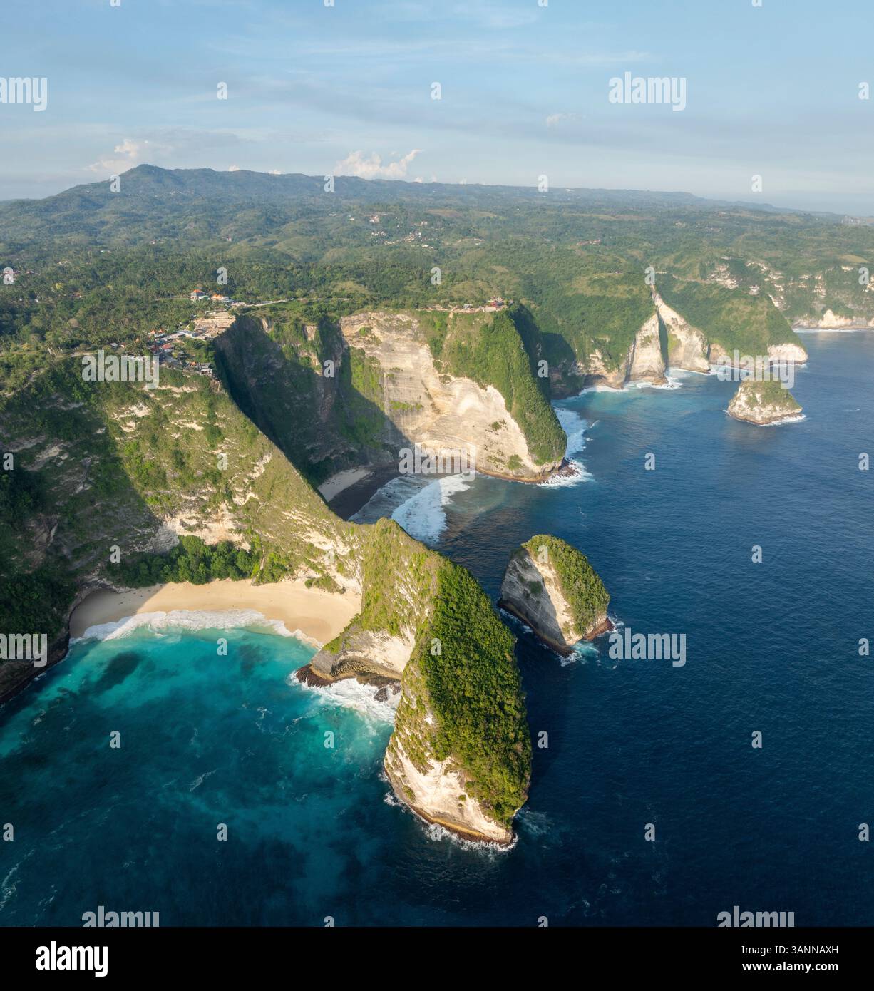Aerial view of beautiful cliffs and serene beach along the blue ocean ...