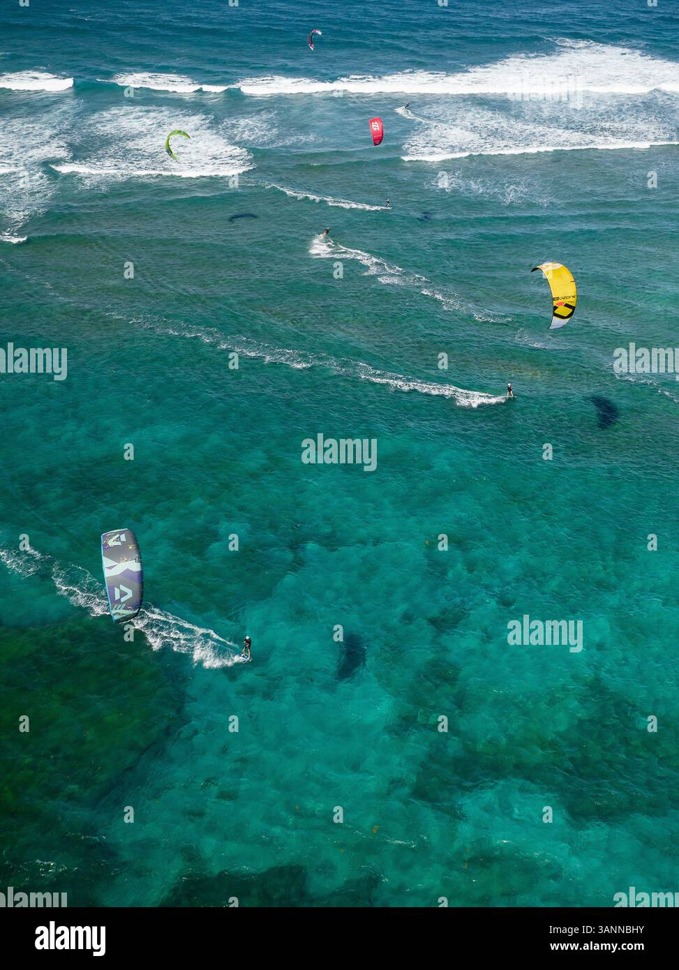 Aerial view of kite surfers riding waves in the beautiful tropical ...