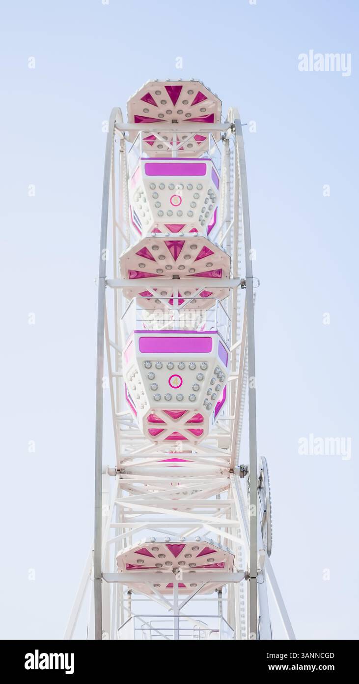 Side View of a Pink and White Amusement Park Carousel Against a Clear ...