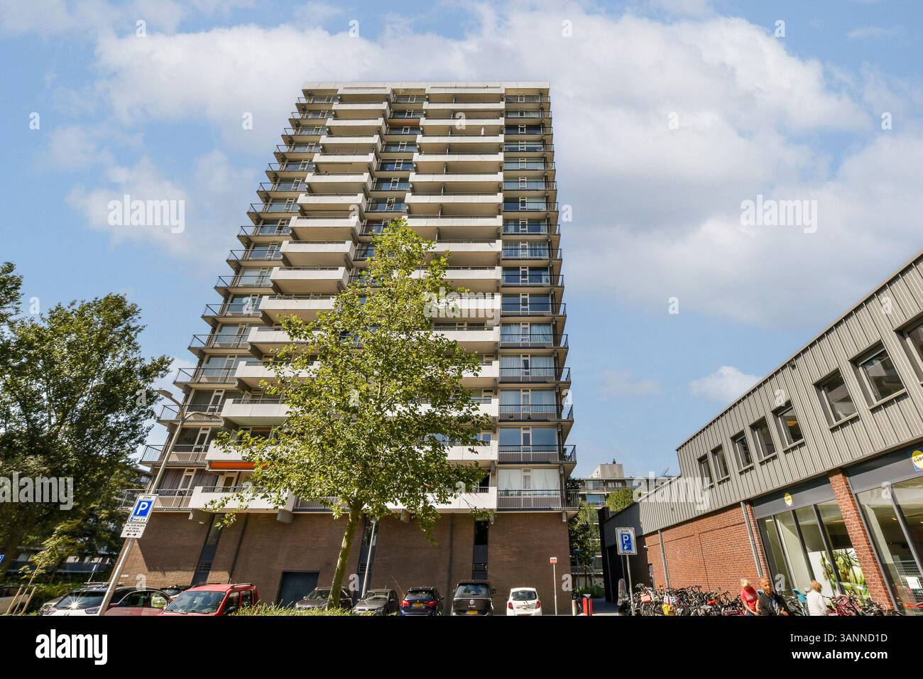 A contemporary multi-story apartment building featuring balconies and ...