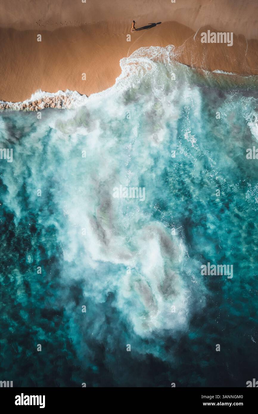 Aerial view of crispy waves along the shoreline at Playa de los Amantes ...