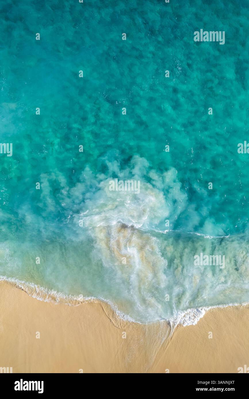 Aerial view of crispy waves along the shoreline at Playa de los Amantes ...