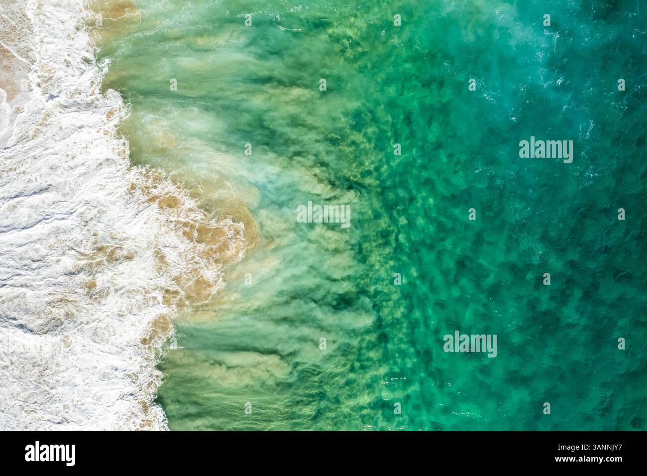 Aerial view of crispy waves along the shoreline at Playa de los Amantes ...