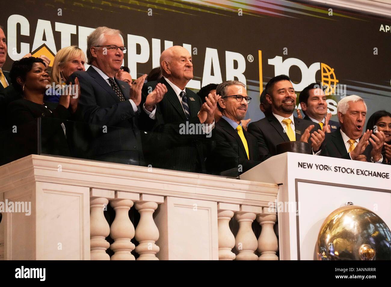 Caterpillar CEO Jim Umpleby, center, rings the New York Stock Exchange opening bell, Tuesday ...