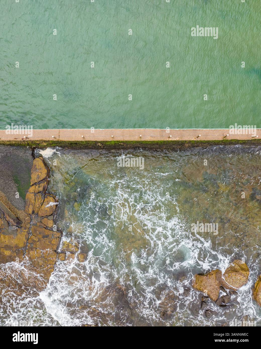 Aerial view of a person swimming in North Narrabeen Rockpool, New South ...