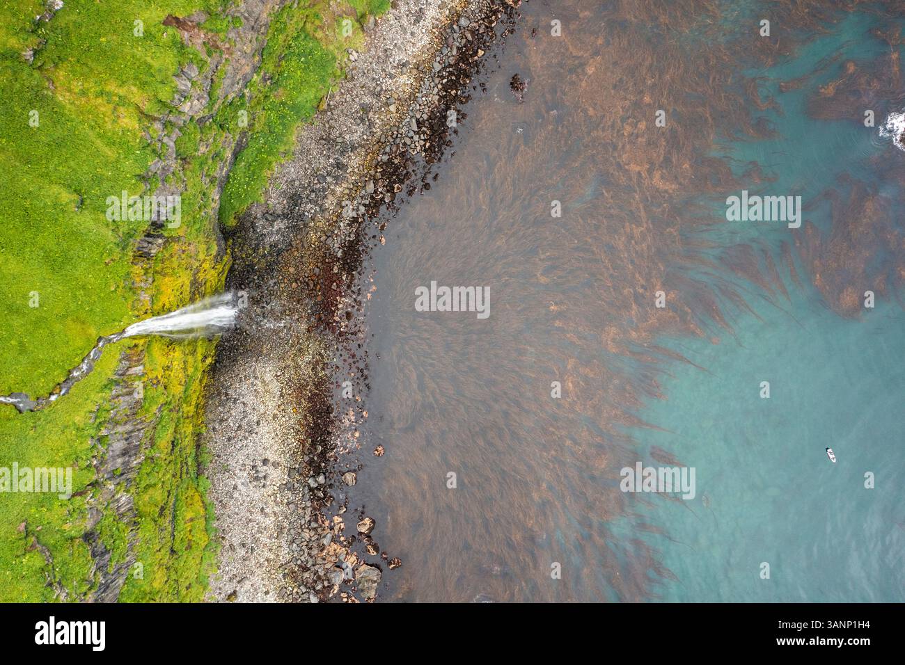 Aerial view of a waterfall along the coast, Driftwood Bay, Unalaska ...