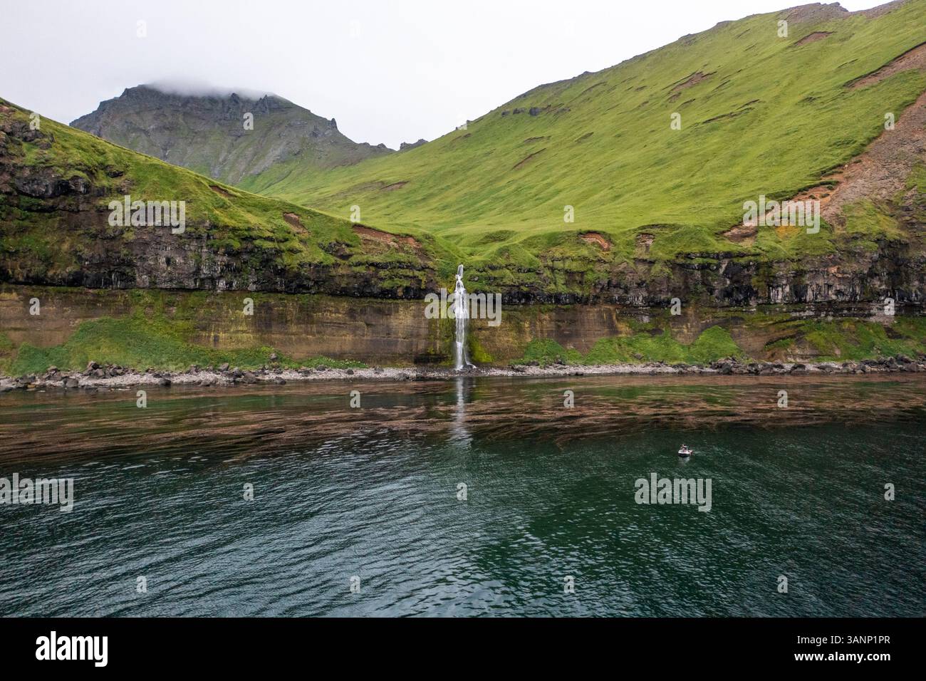 Aerial view of a waterfall along the coast, Makushin, Unalaska island ...