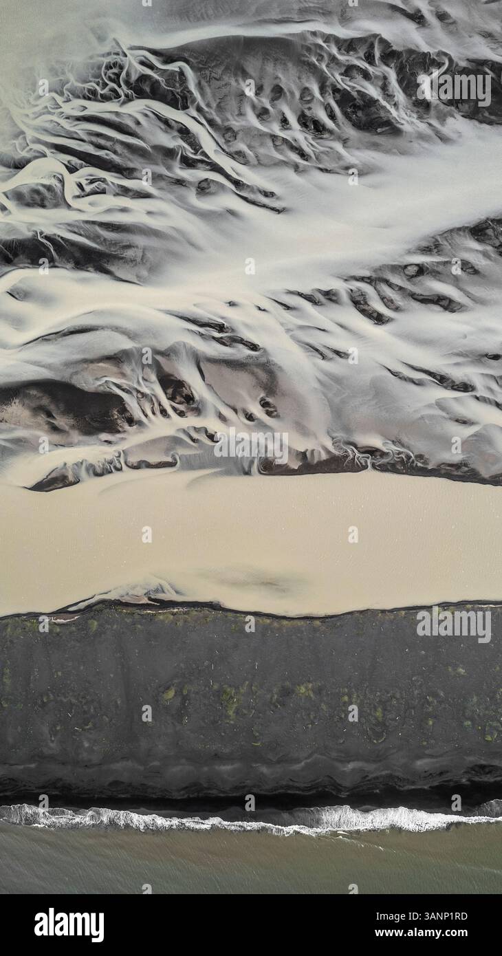 Aerial view of water formation at river estuary and Fjorur beach ...
