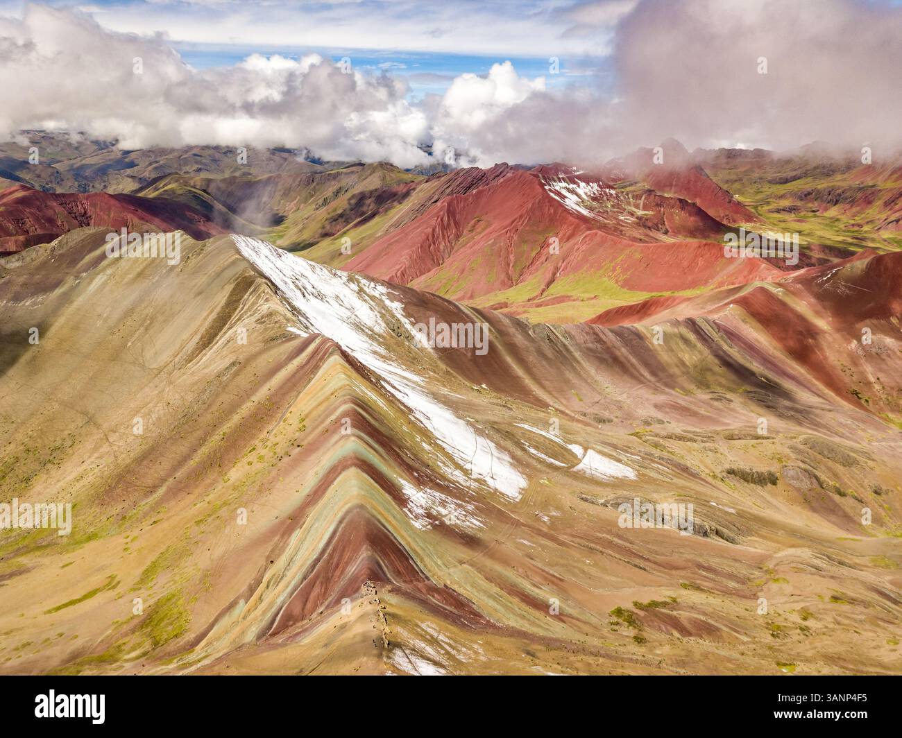 Aerial view of peaks of Vinicunca in clouds, Rainbow Mountain, Peru ...