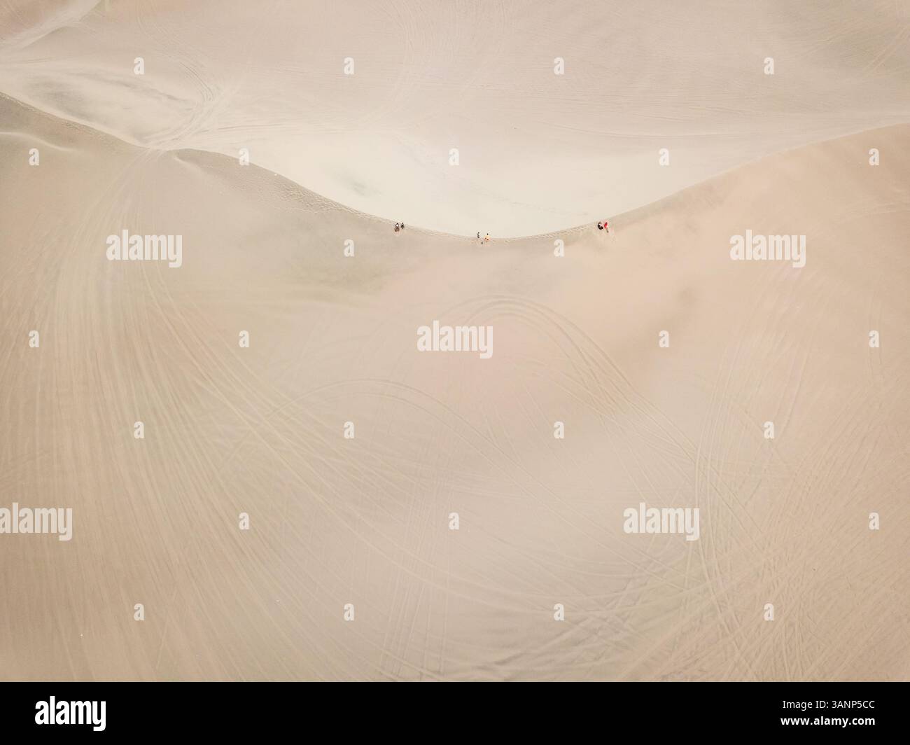 Aerial view of tourists sitting on dunes in Ica desert, Peru Stock ...